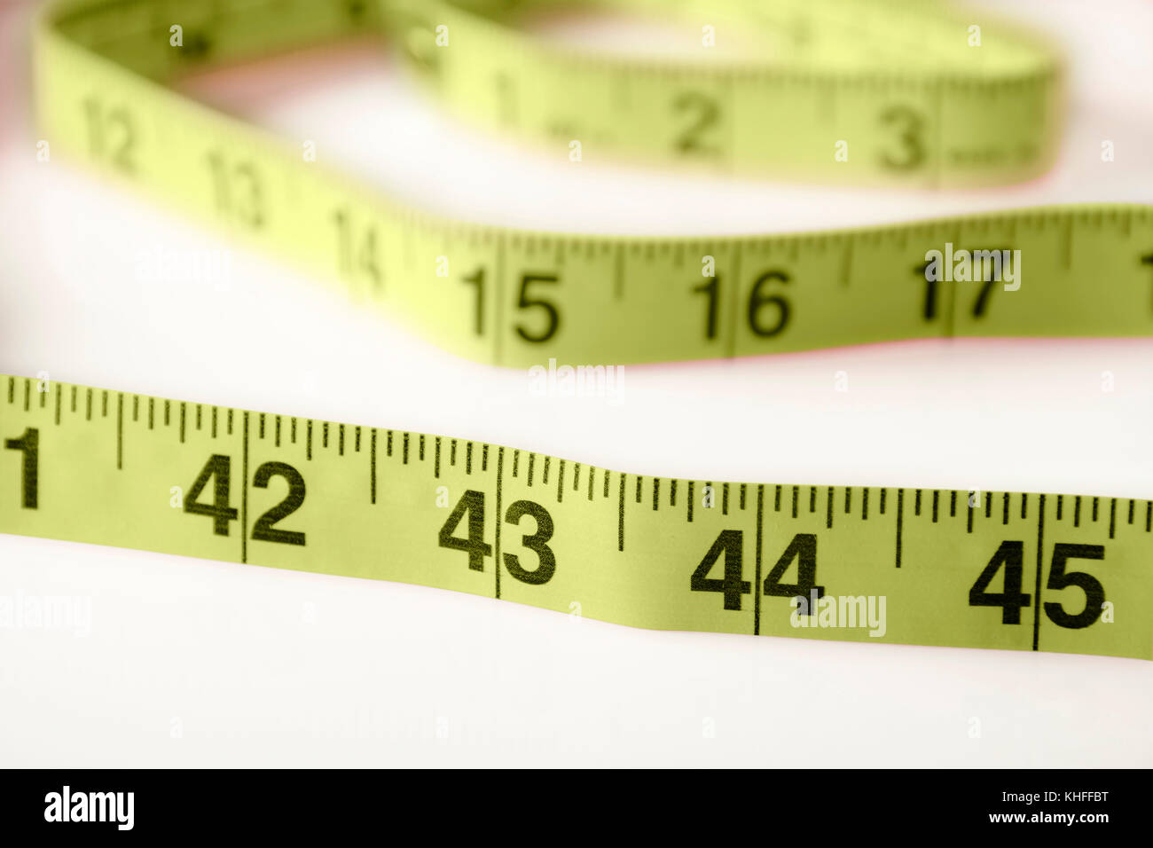 Measuring tape on white with slight shadows Stock Photo - Alamy