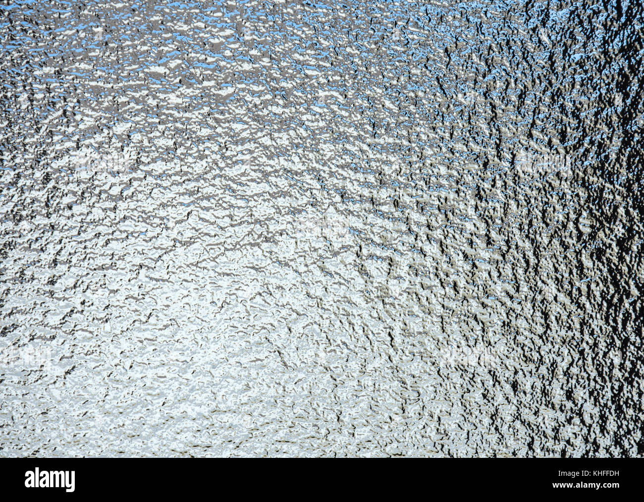 Closeup of textured glass with light shining through, cool feeling ...