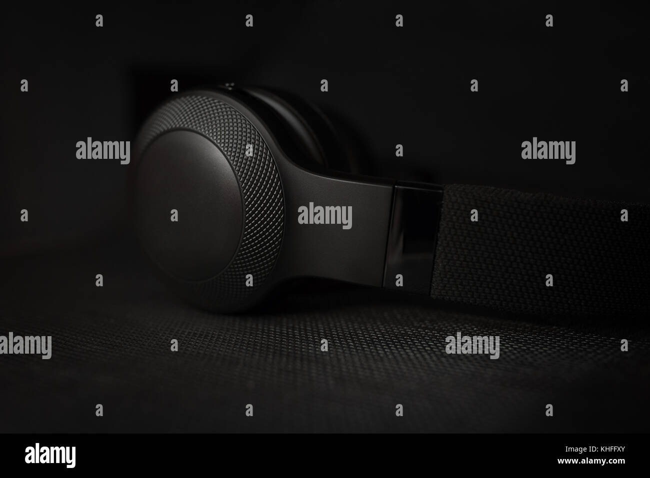 Black headphones on black dark background Stock Photo - Alamy