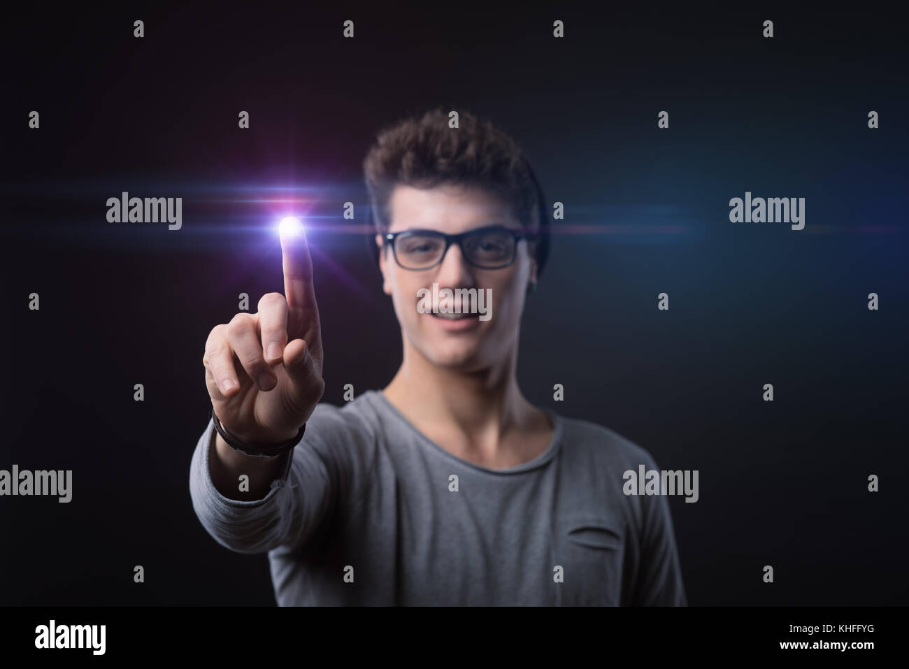 Smiling teenager using touch screen interface with index finger Stock ...