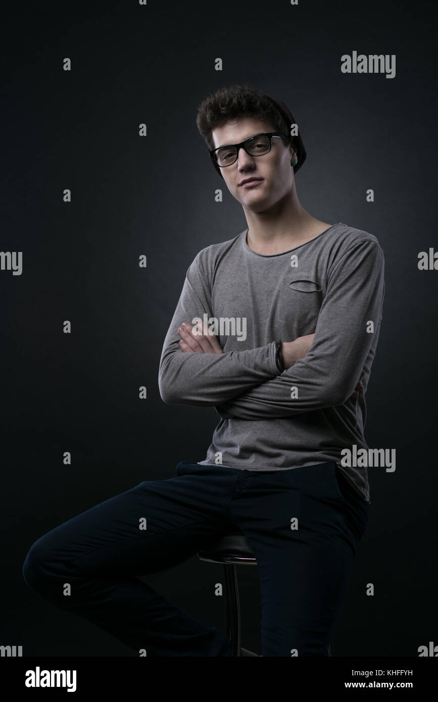 Smiling handsome nerd guy portrait on dark background Stock Photo - Alamy