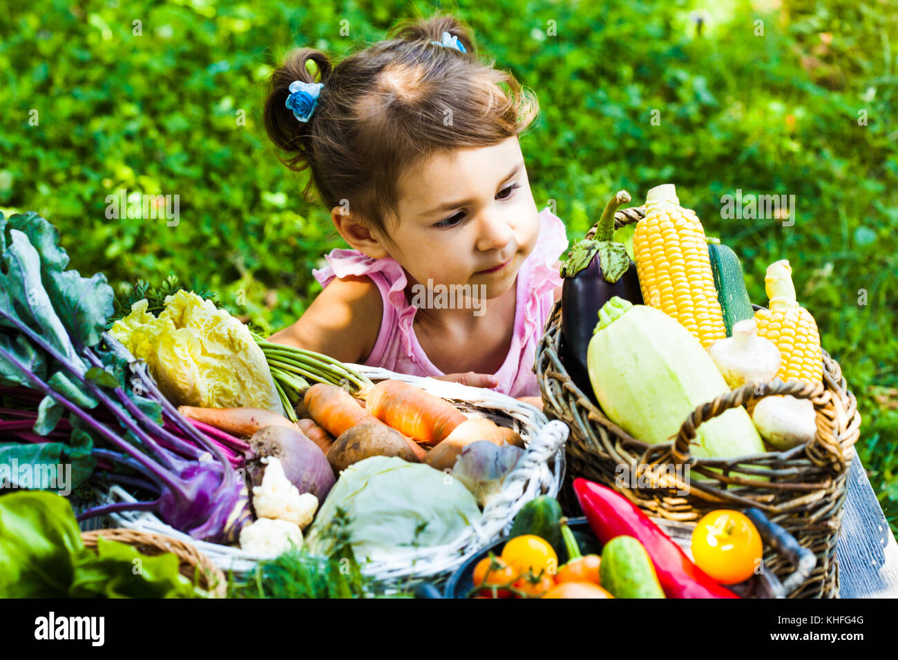 Lovely girl plays with vegetables Stock Photo - Alamy