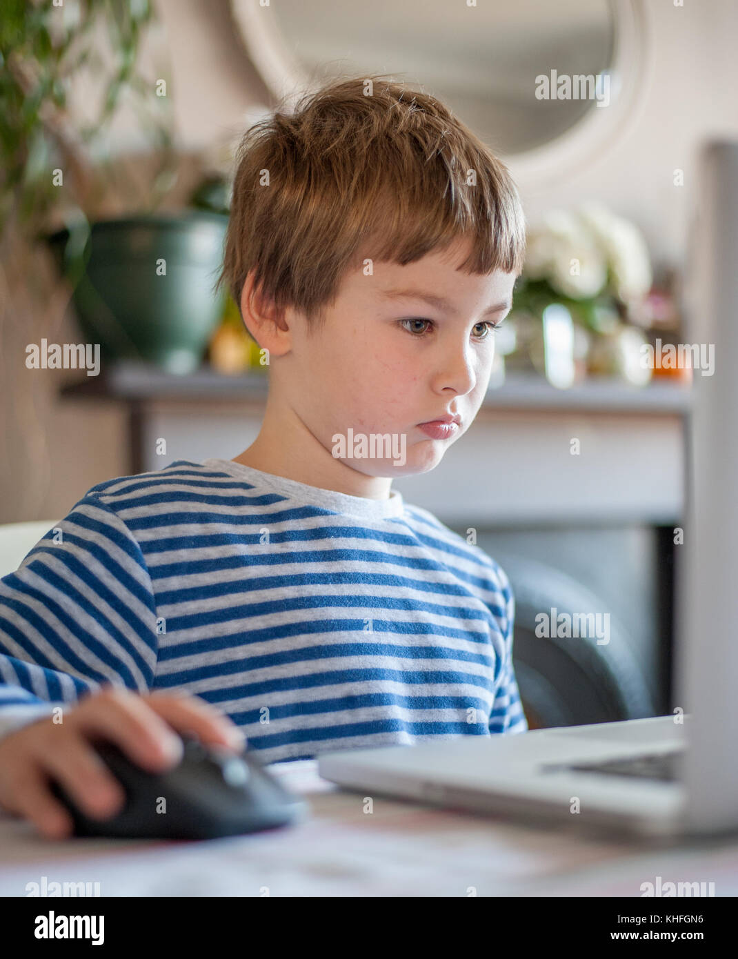 A boy looking at the laptop screen Stock Photo - Alamy