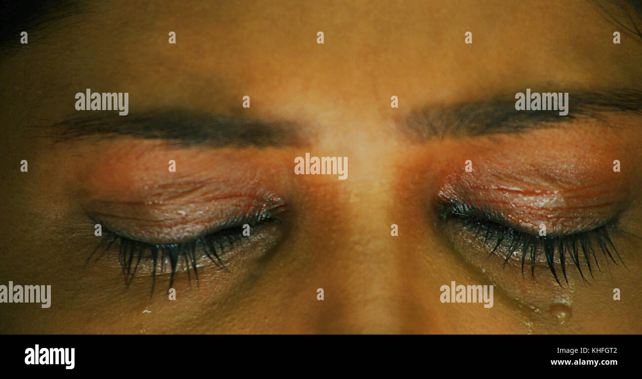 Eye close, Closeup of girl crying with tear rolling down her cheek ...