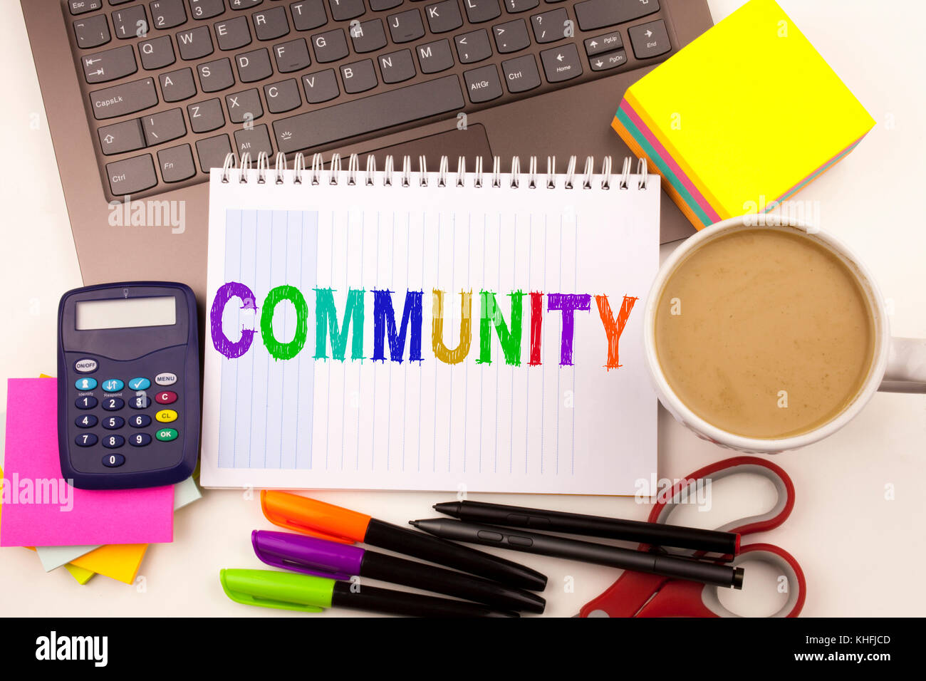 Community text in the office with surroundings such as laptop, marker ...