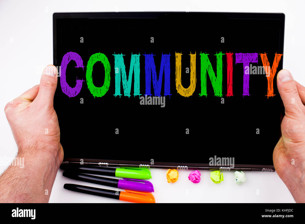 Community text written on tablet, computer in the office with marker ...