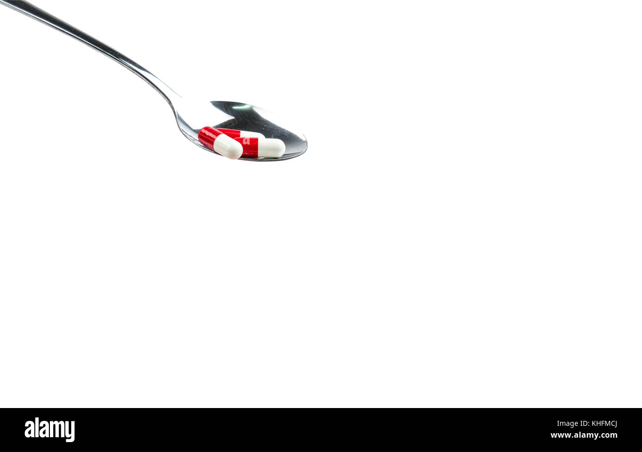 Antibiotic capsule pills in stainless steel spoon isolated on ...