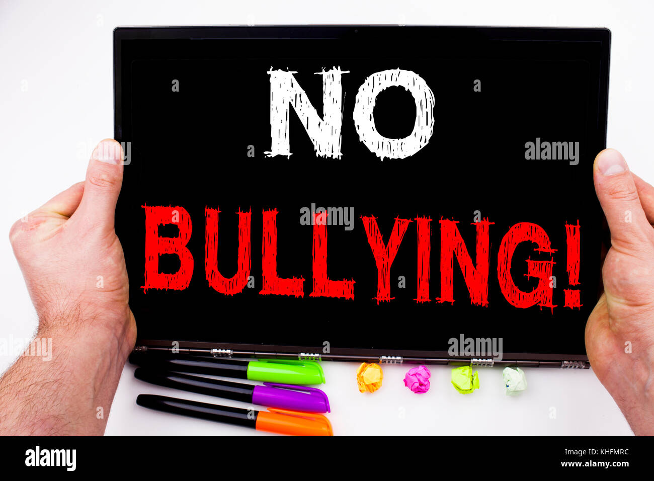 No Bullying written on tablet, computer in the office with marker, pen ...