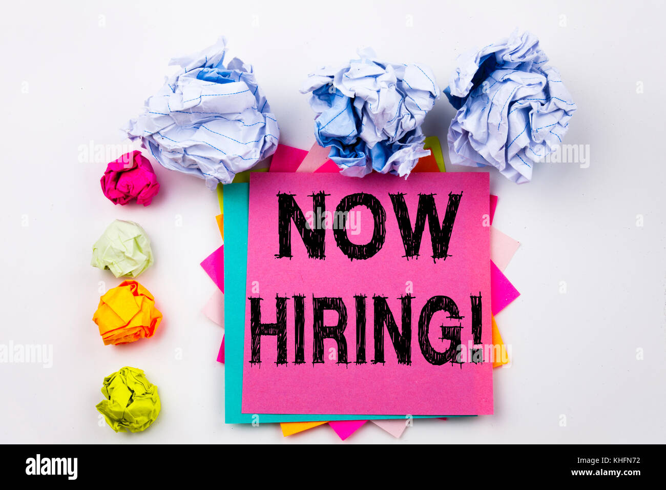 Writing text showing Now Hiring written on sticky note in office with ...