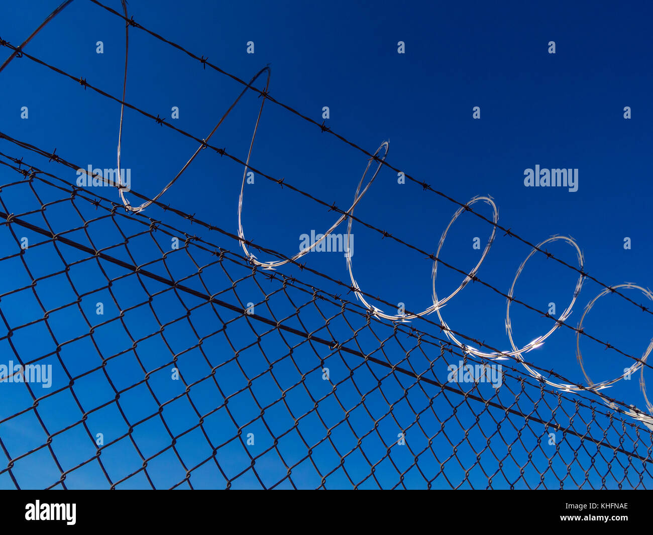 Femce with barb wire close up shot Stock Photo - Alamy