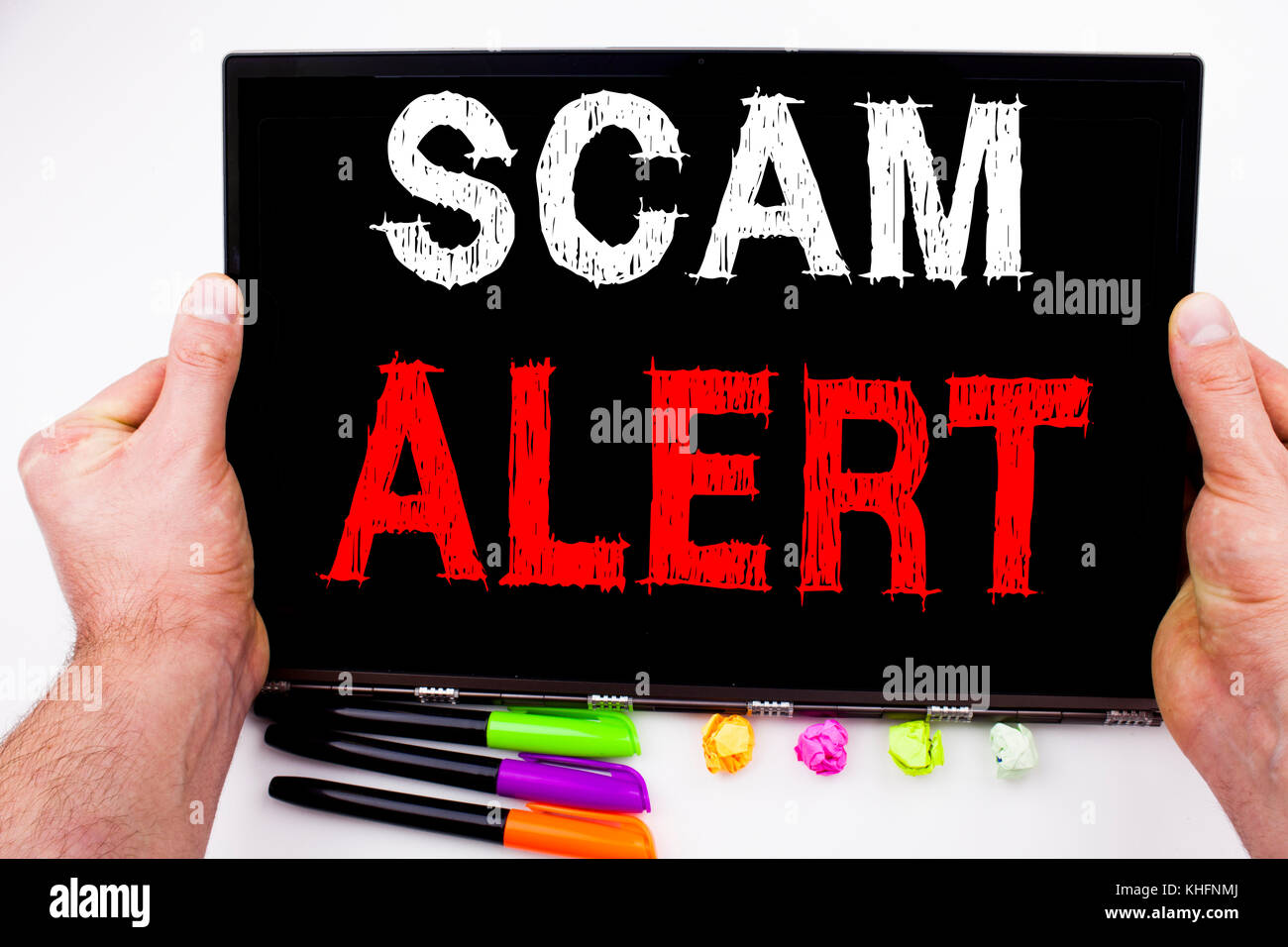 Scam Alert text written on tablet, computer in the office with marker ... Scam Alert text written on tablet, computer in the office with marker ...