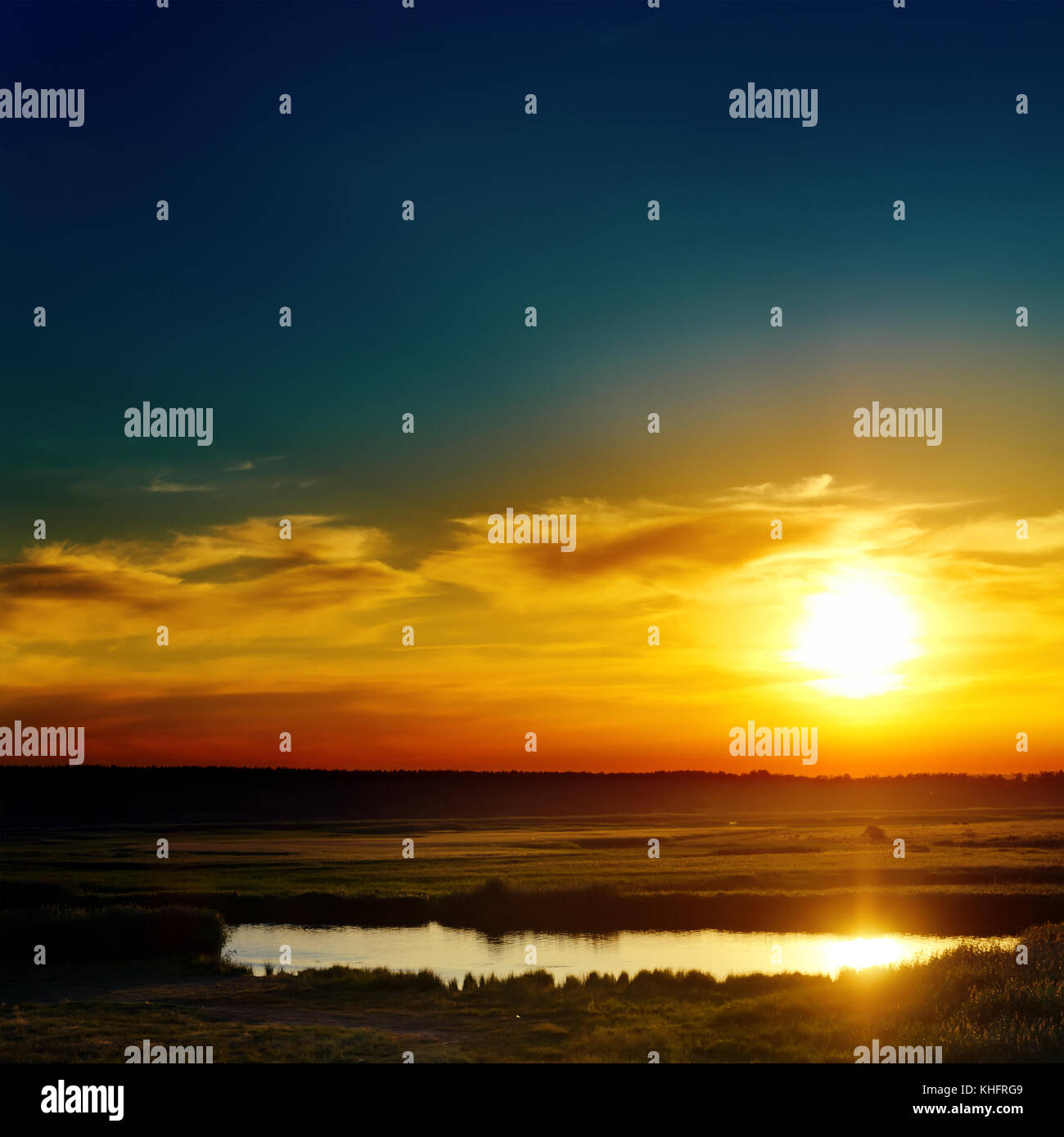 blue and orange sunset over lake Stock Photo - Alamy