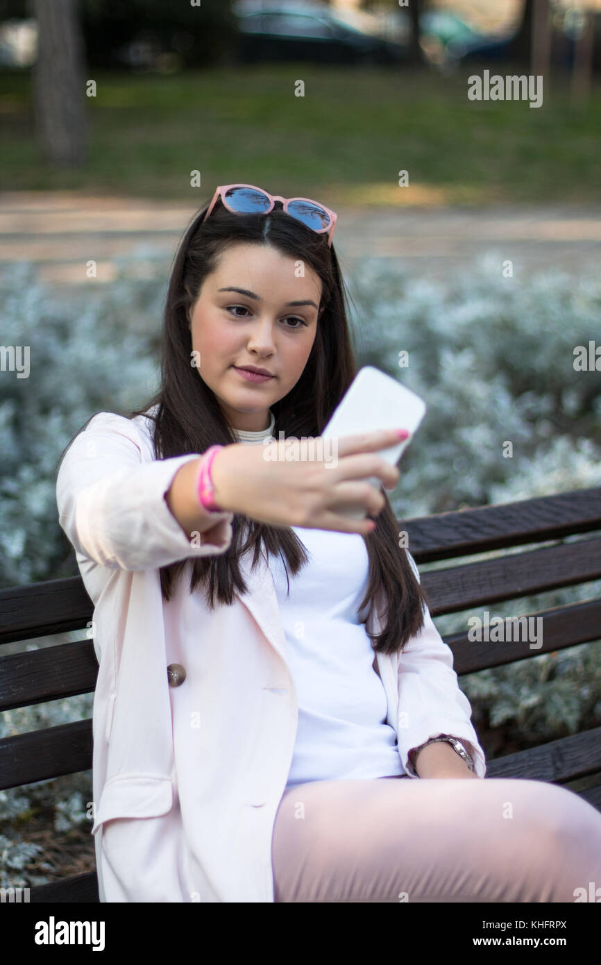 Young woman with smartphone outdoors Stock Photo - Alamy
