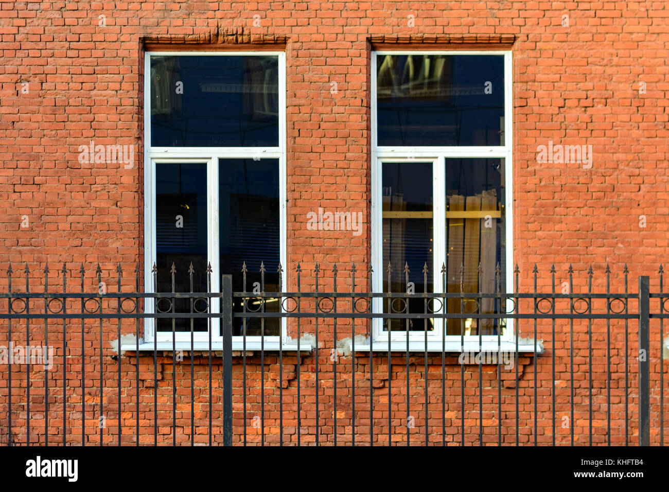 Two rectangular windows with white frame, on a background of wall of ...