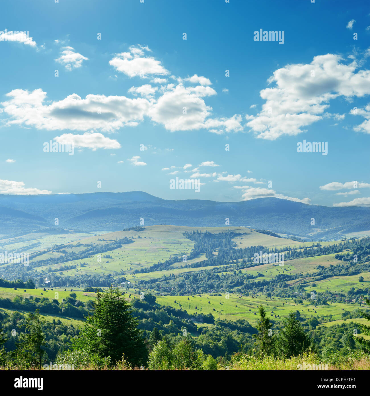 clouds over green mountain Stock Photo - Alamy