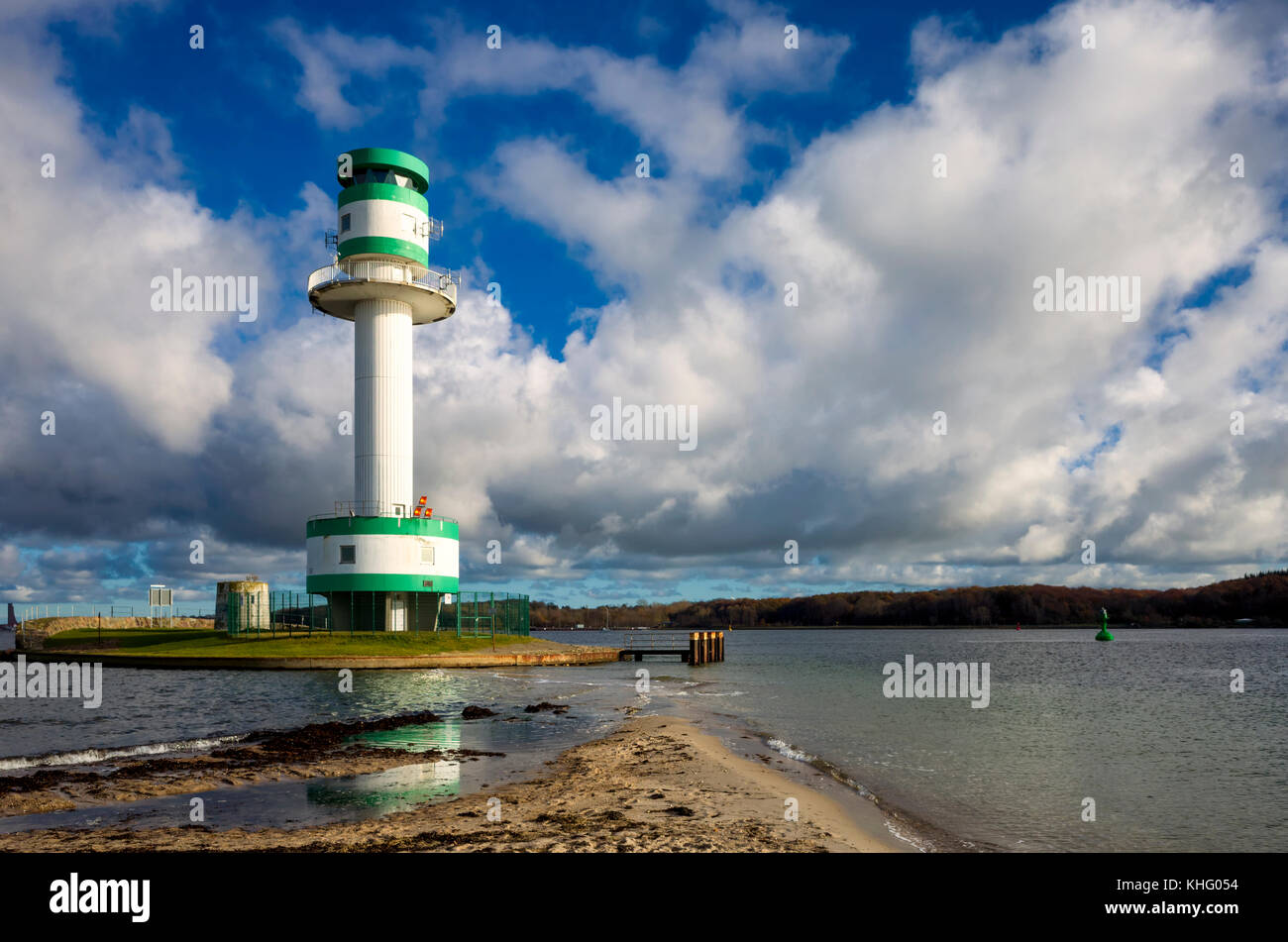 A lighthouse just off the beach on the edge of the fjord at Kiel ...