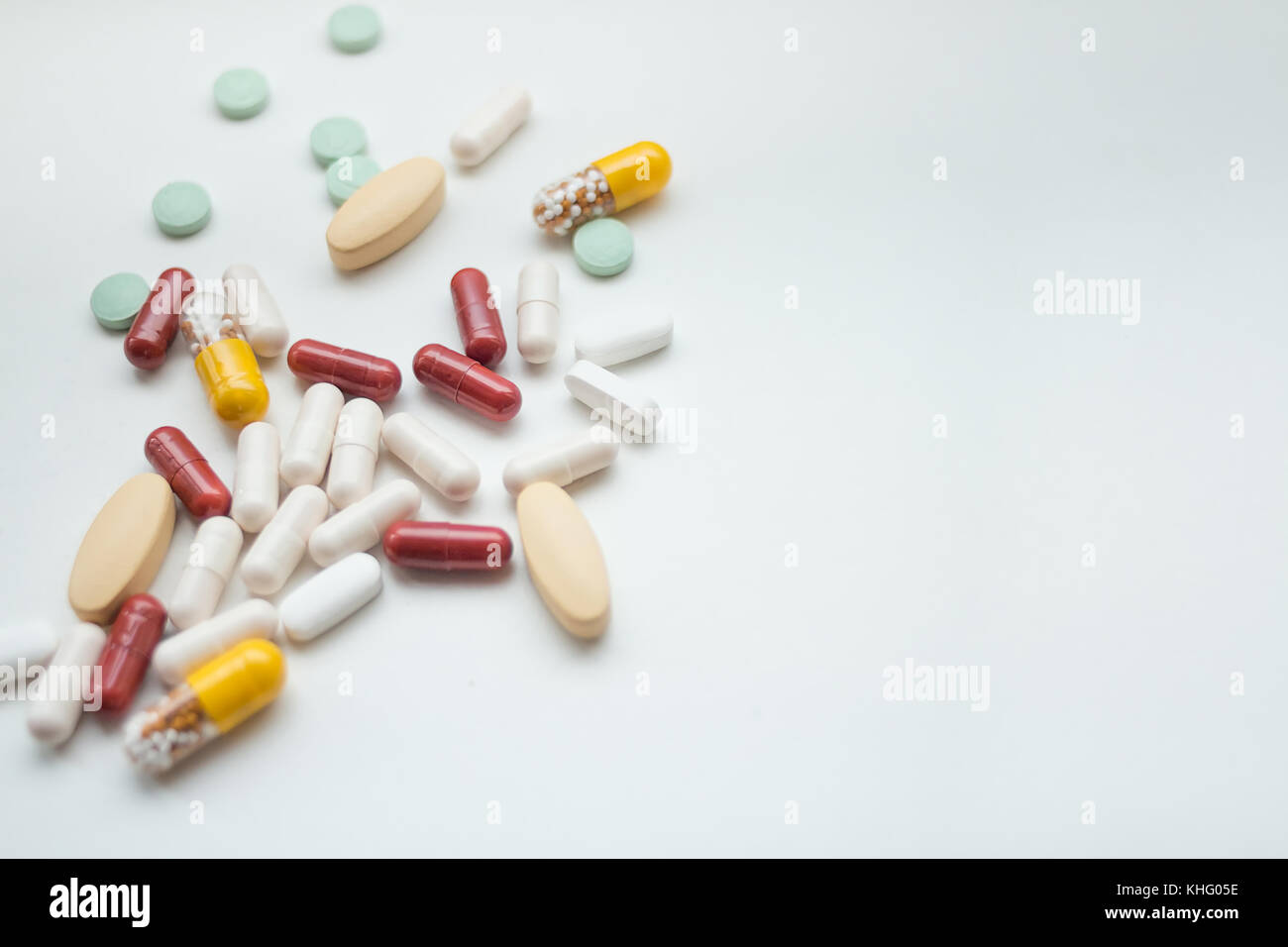 Assorted pills and tablets, isolated on white background various colors ...
