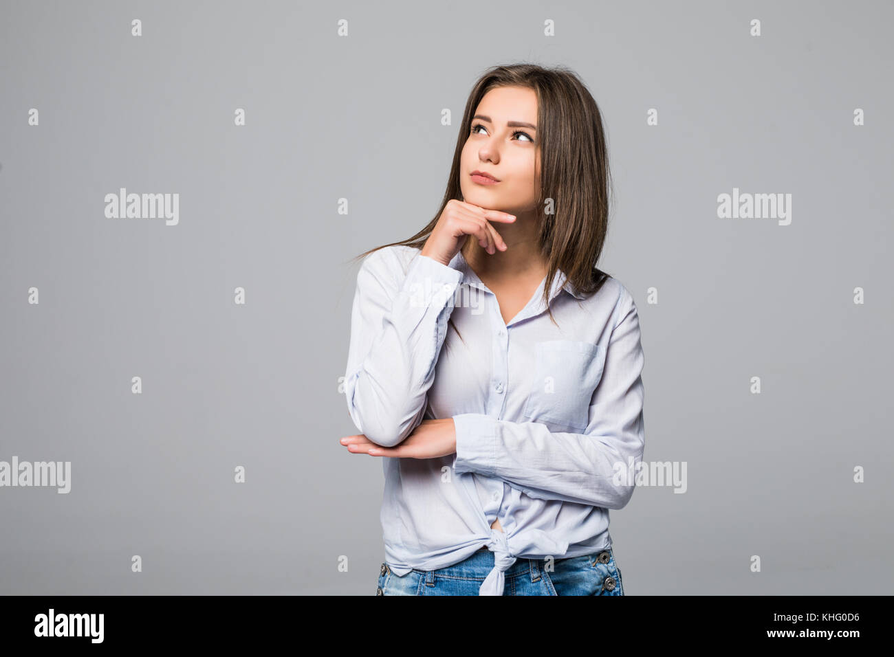 Attractive creative woman using her imagination sitting in deep thought ...