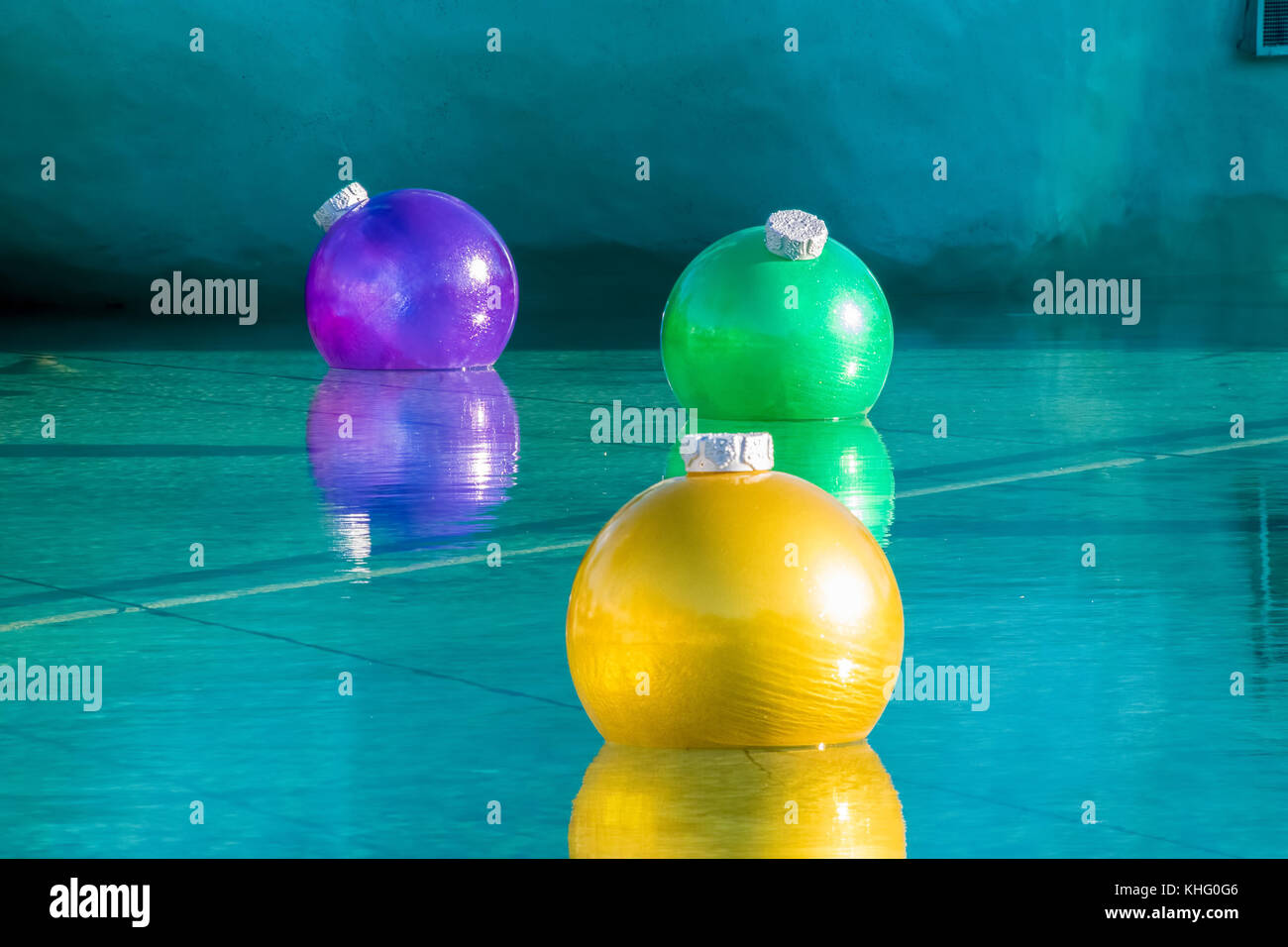 Different coloured floating Christmas baubles Stock Photo - Alamy