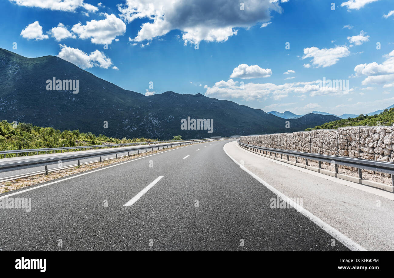 High-speed country road among the mountains Stock Photo - Alamy