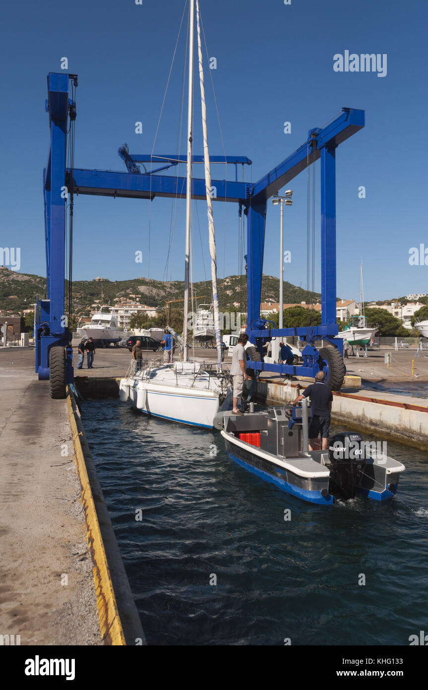 France, Corsica, Calvi, Sailboat being hauled out with crane Stock ...