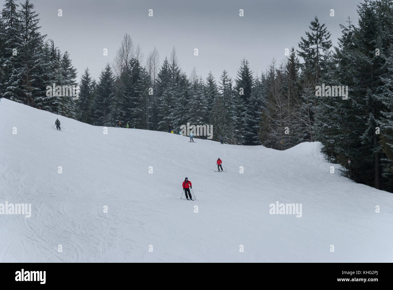 Aerial photo of a group of people skiing and snowboarding down run ...