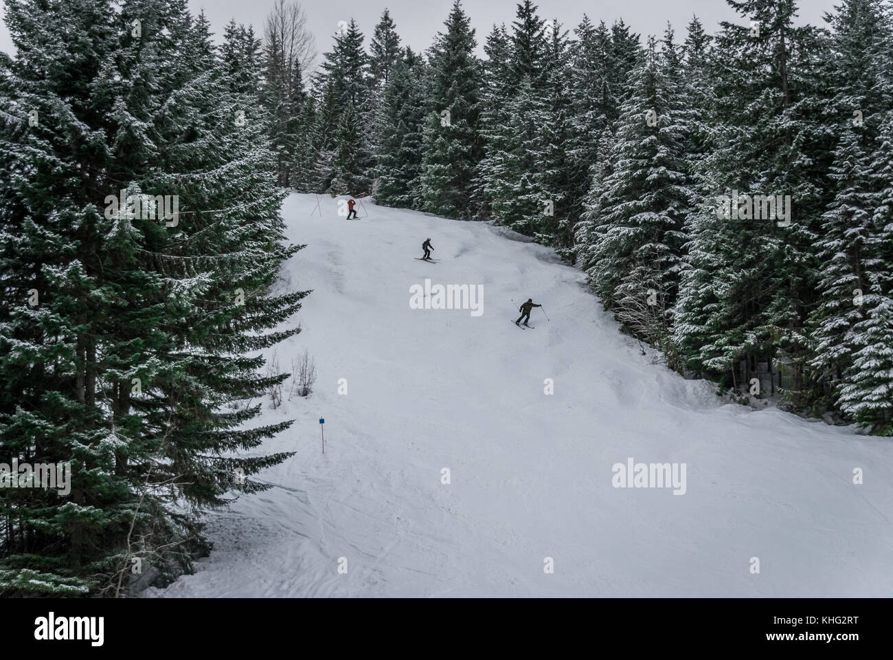 Aerial photo of a group of people skiing and snowboarding down run ...