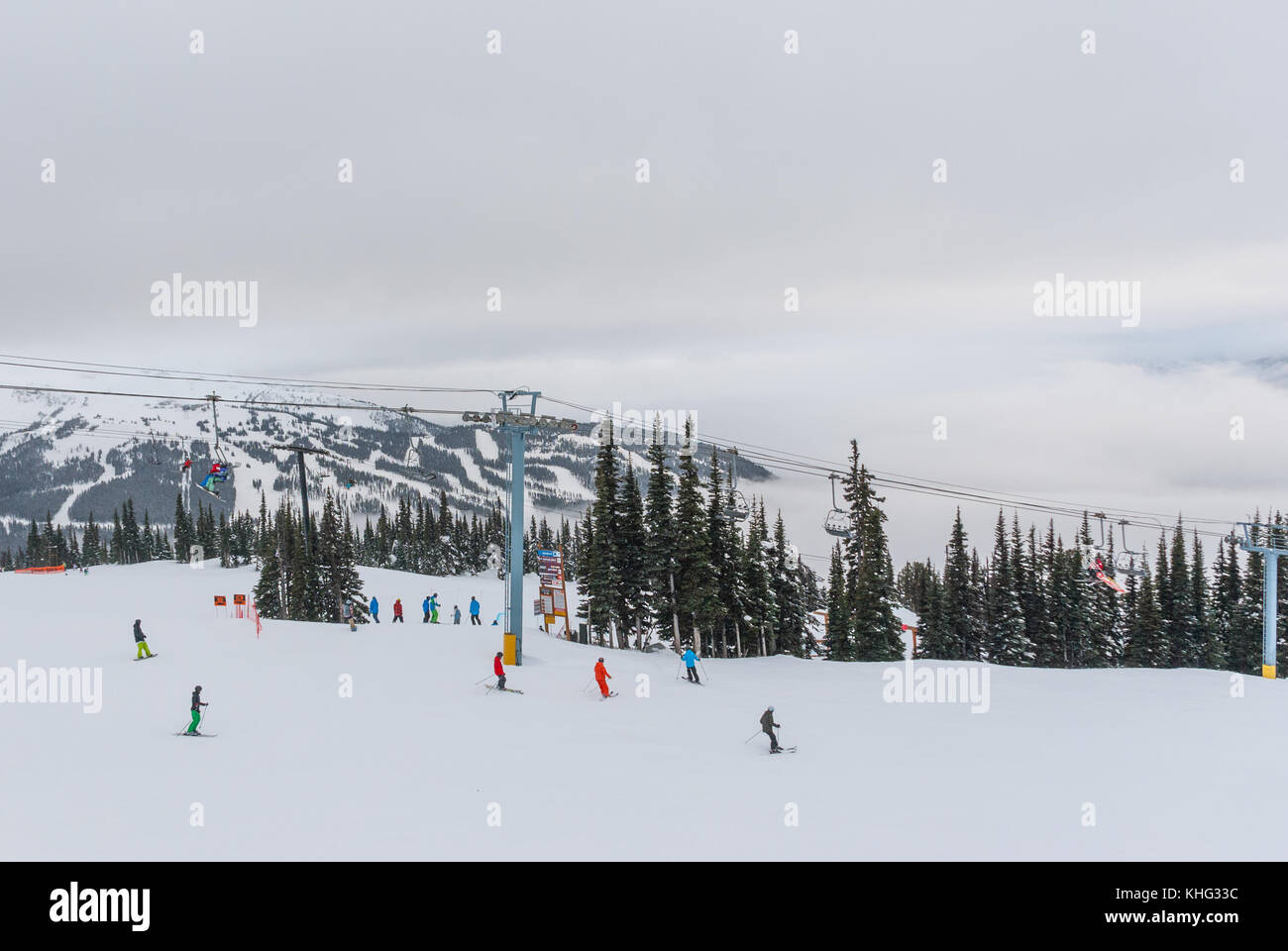 Aerial photo of large group of people skiing and snowboarding down ...
