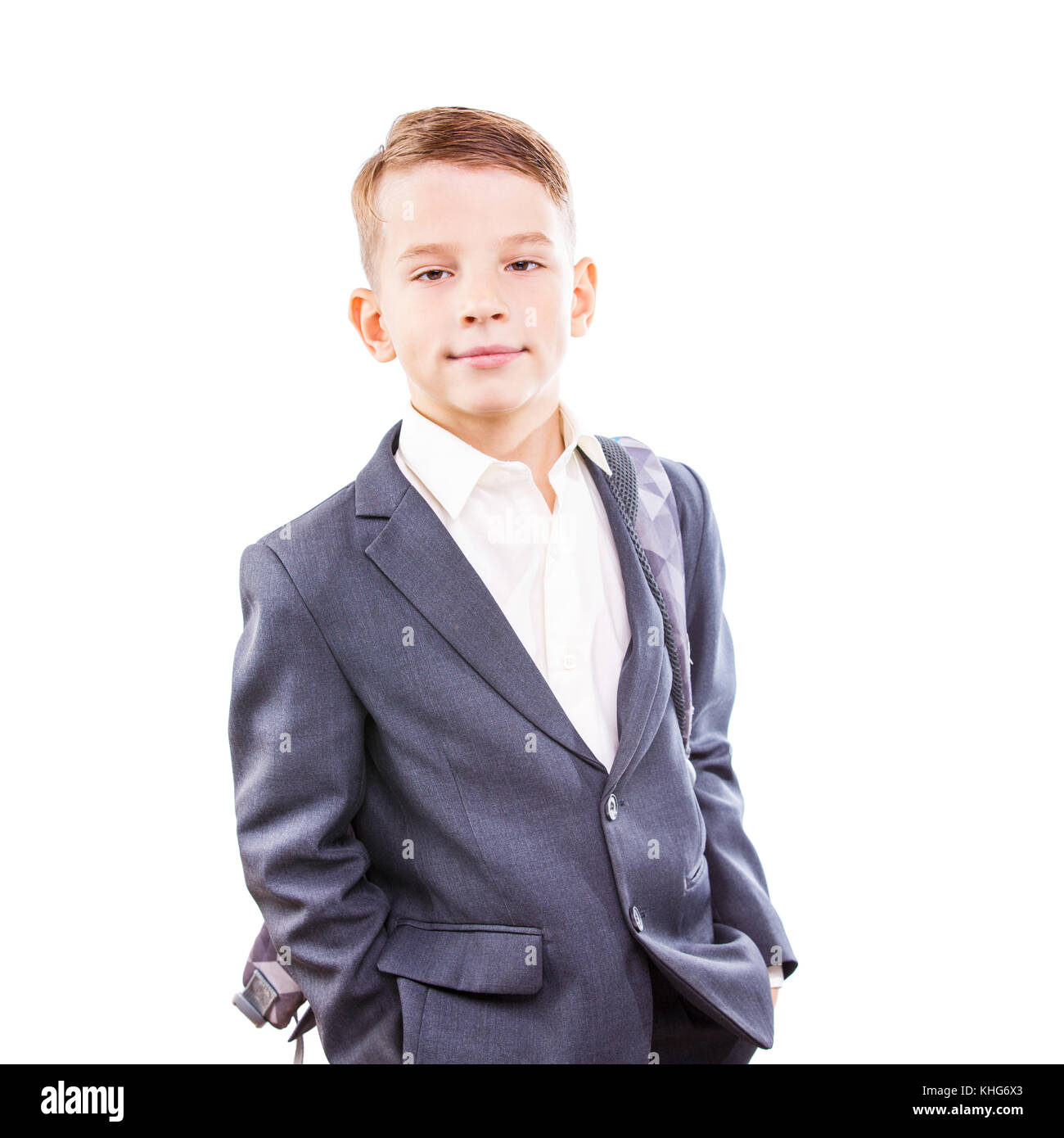 Serious young male student of primary school isolated on white ...