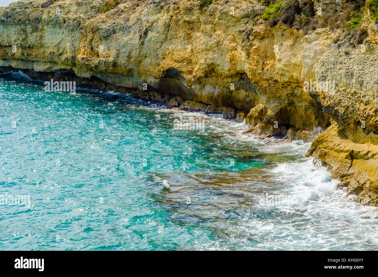 high cliff above the sea, summer sea background, many splashing waves ...