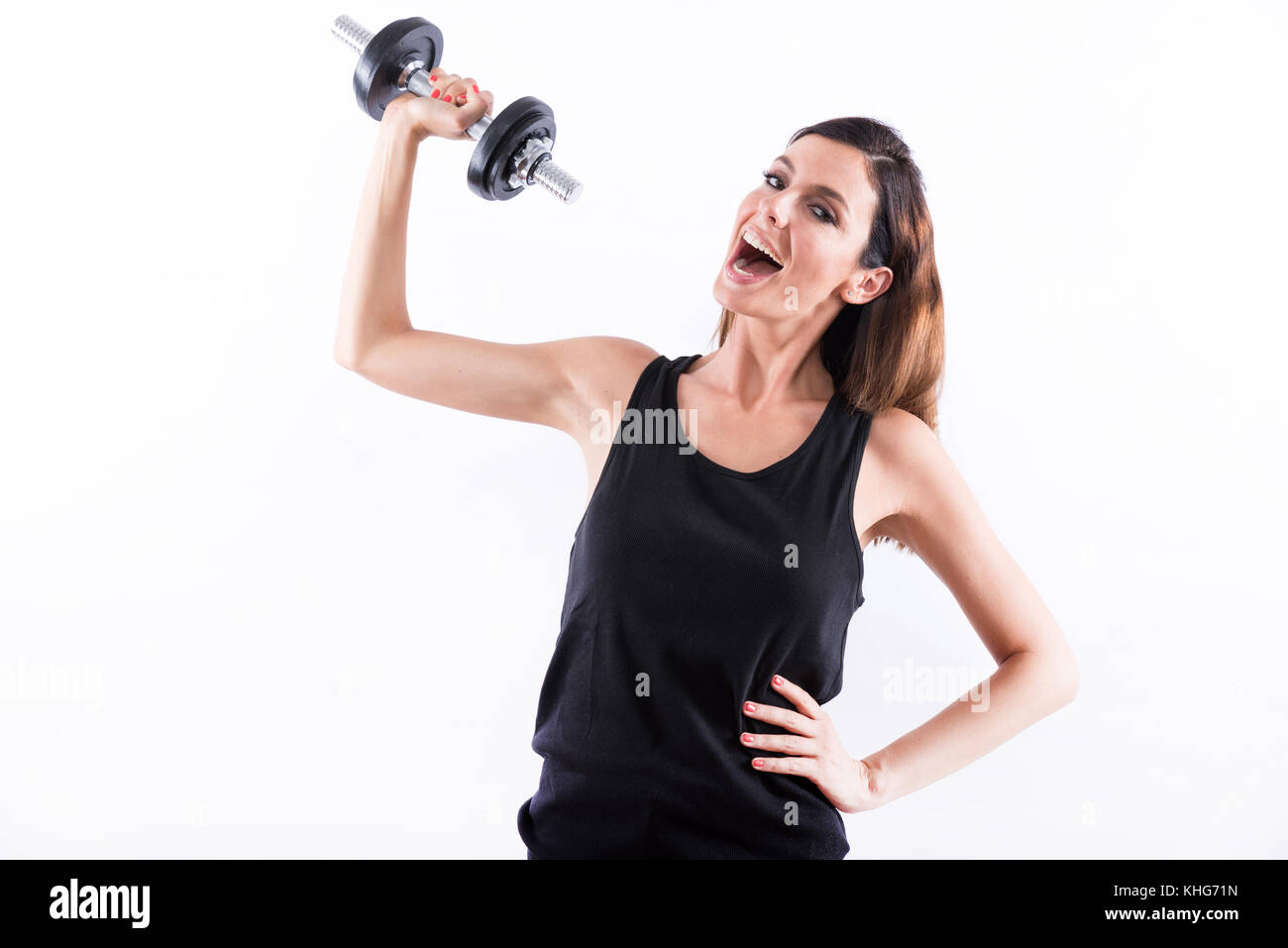A beautiful young woman lifting weight and feeling happy Stock Photo ...