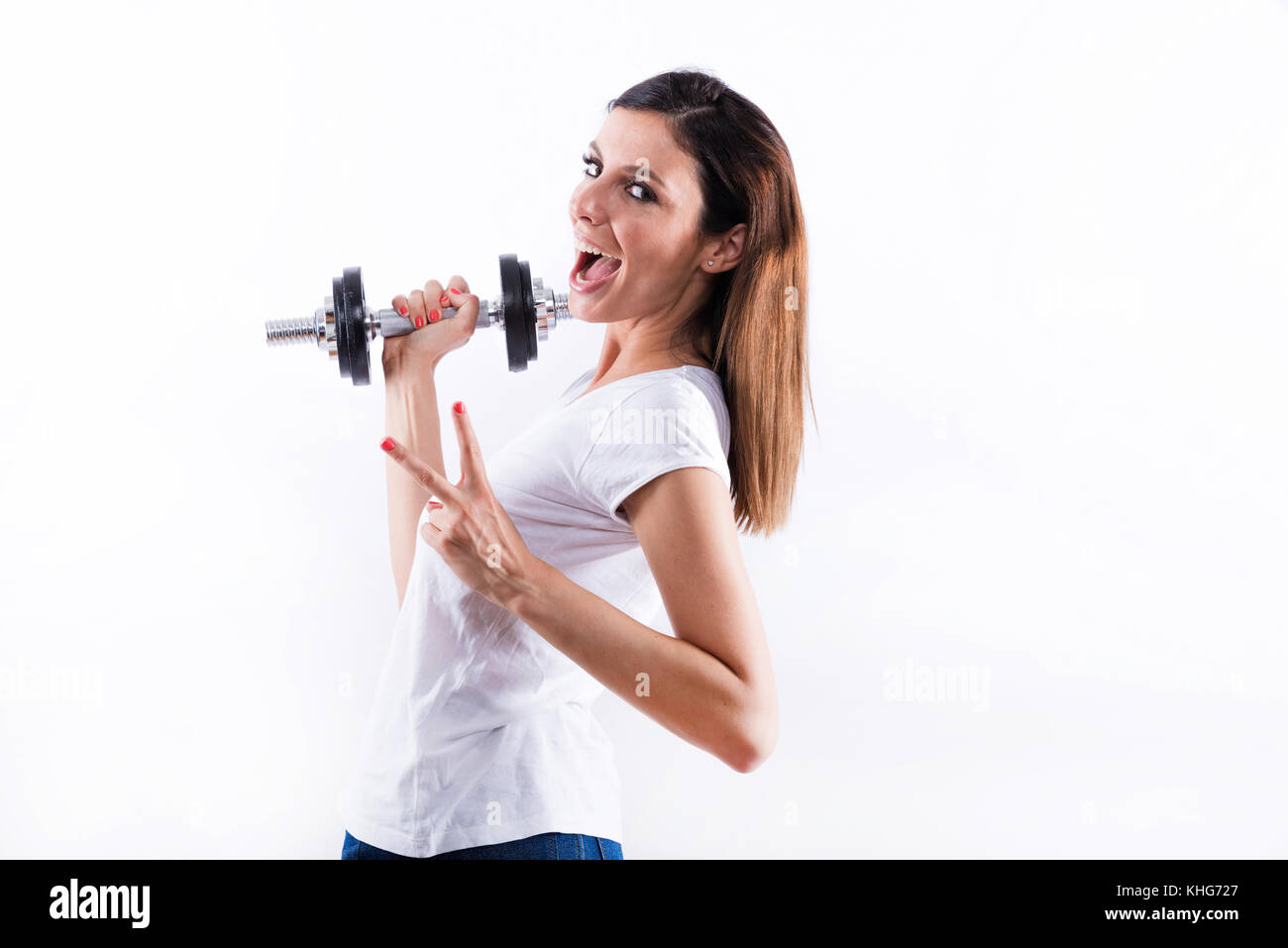 A beautiful young woman lifting weight and feeling happy Stock Photo ...