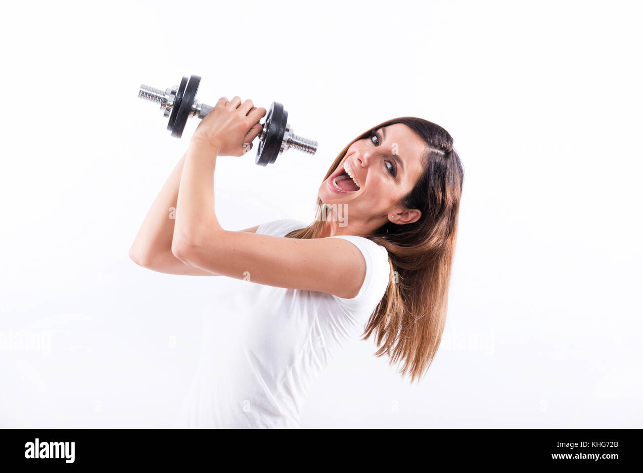 A beautiful young woman lifting weight and feeling happy Stock Photo ...