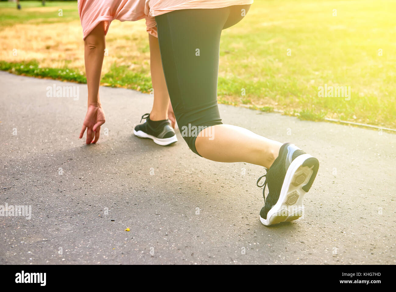 Close up from the back of the legs of a young woman in run starting ...