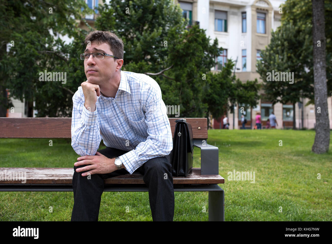 Portrait of a Business man being bored on a bench Stock Photo - Alamy