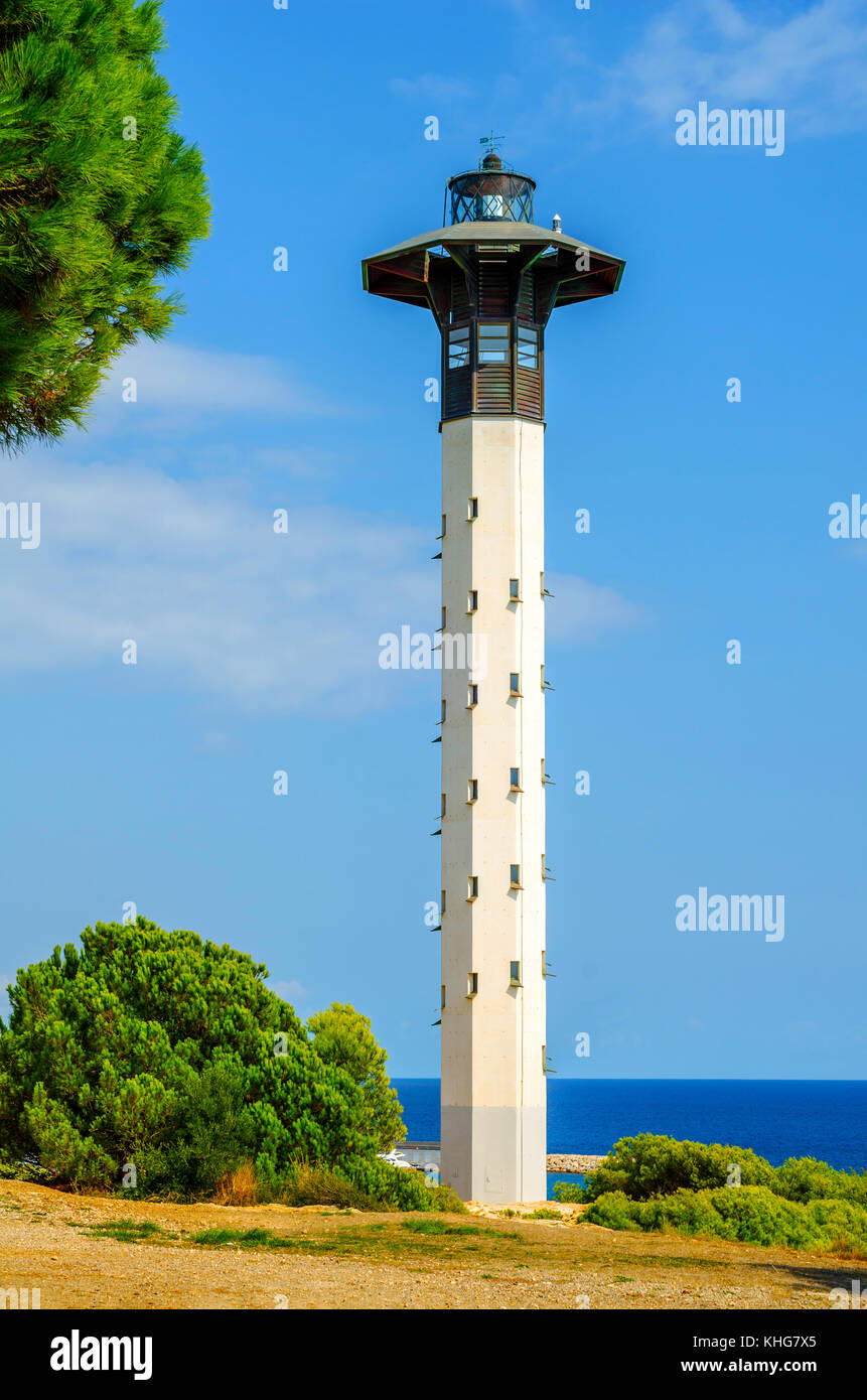 Lighthouse tower and blue summer sky, the safe return of the ship ...