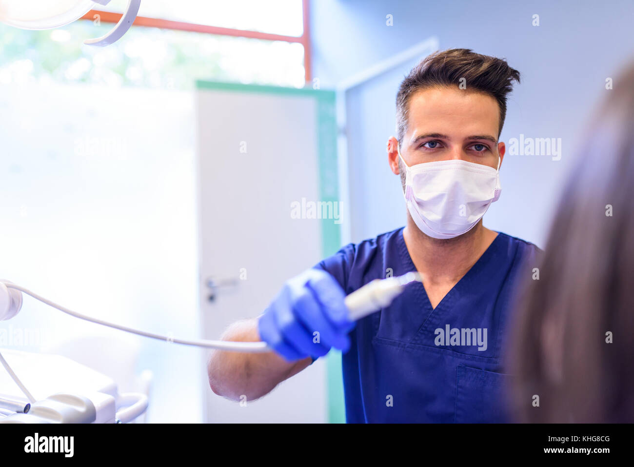 A young Dentist working in his Practice Stock Photo - Alamy