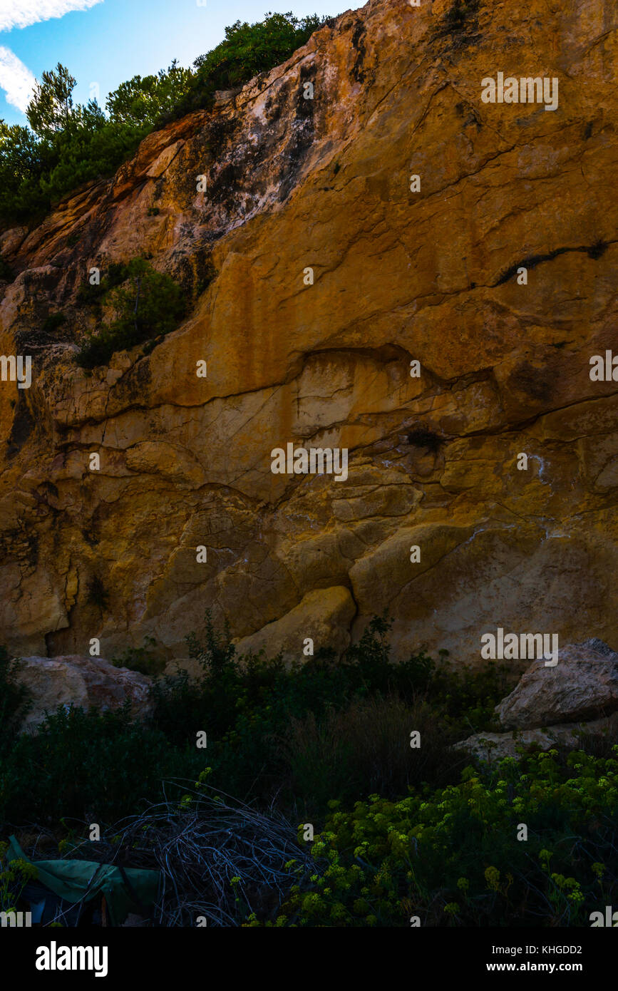 great rock wall, cliff against the blue sky, steep rock cliff, geology ...