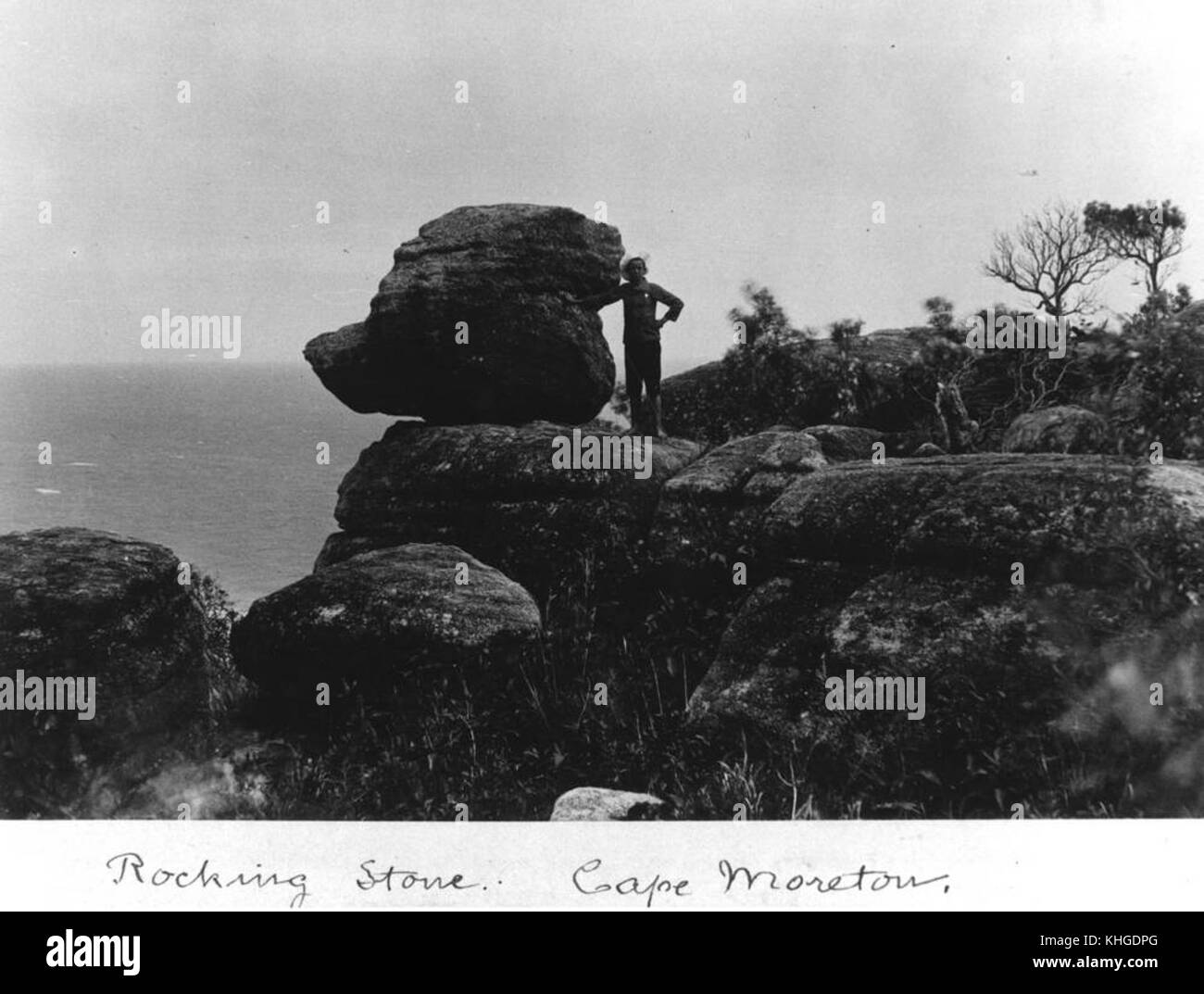 2 157489 Boy standing next to the 'Rocking Stone' at Cape Moreton ...