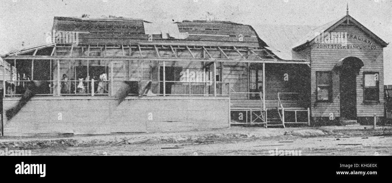 This photograph captures the aftermath of a cyclone that damaged a bank ...