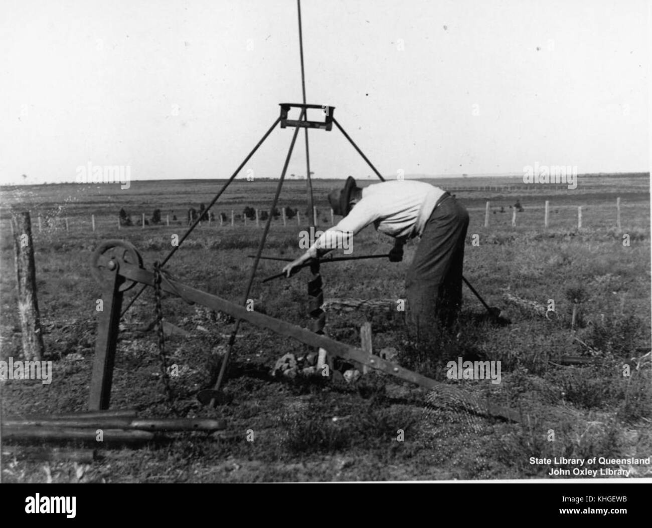 2 159182 Man, aided by machinery, digging post holes in the Blackall ...
