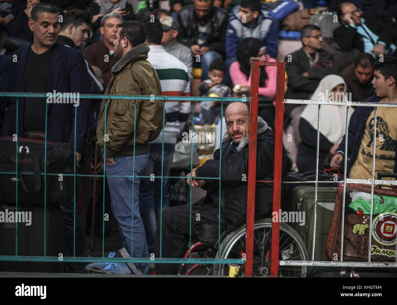 Palestinians gather at a makeshift bus station in a basketball court as ...