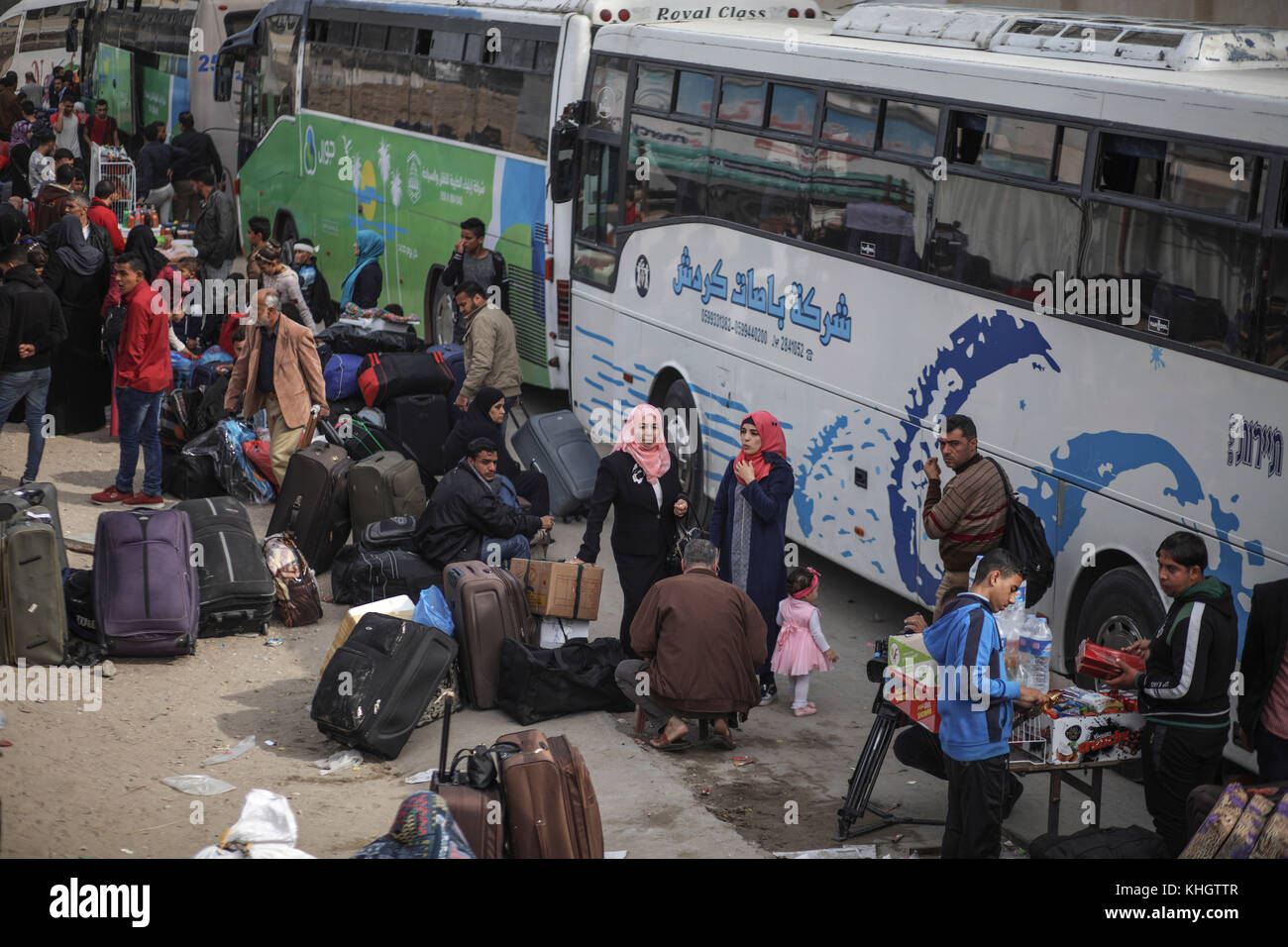 Palestinians gather at a makeshift bus station outside a basketball ...