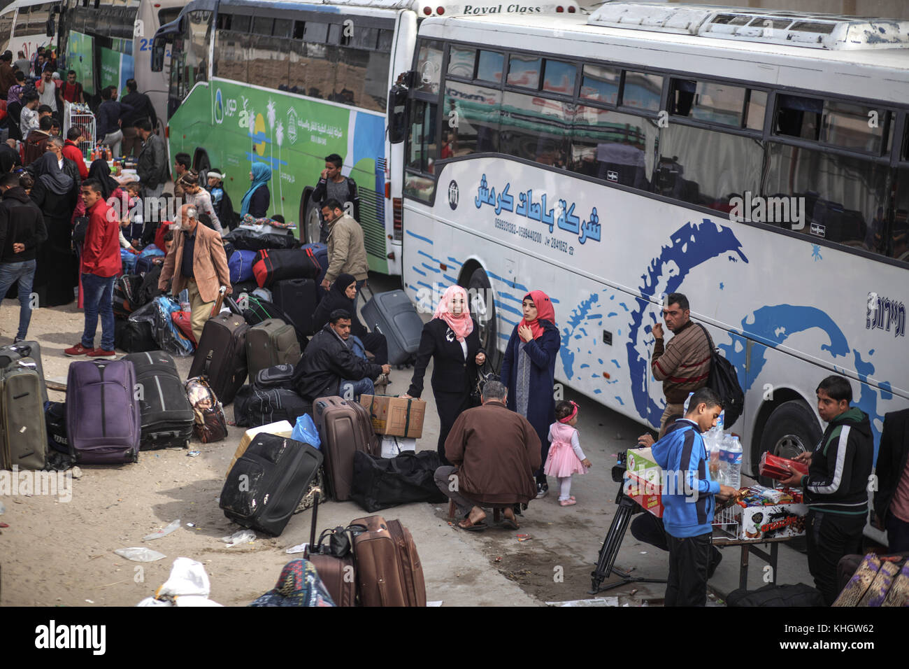 Palestinians gather at a makeshift bus station outside a basketball ...