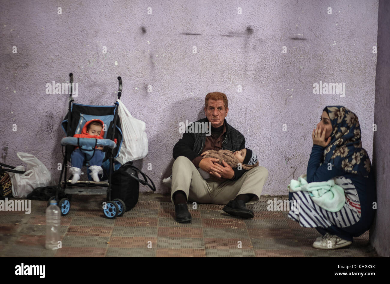 dpatop - A Palestinian family sits at a makeshift bus station in a ...