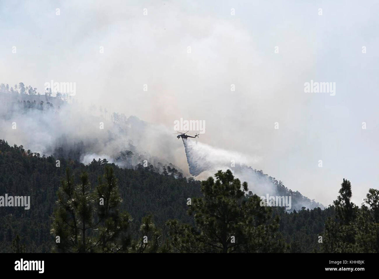 A helicopter makes water drop on the Crow Peak Fire. The Crow Peak Fire ...