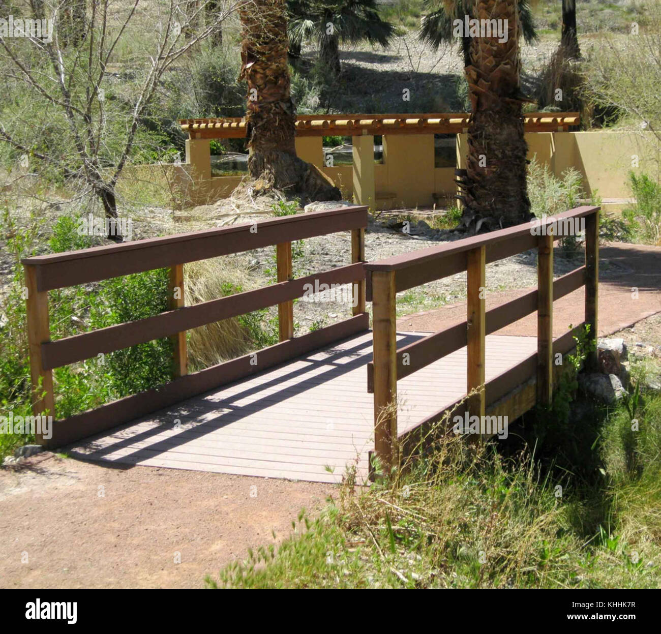 This image showcases a foot bridge and trail, likely within a natural ...