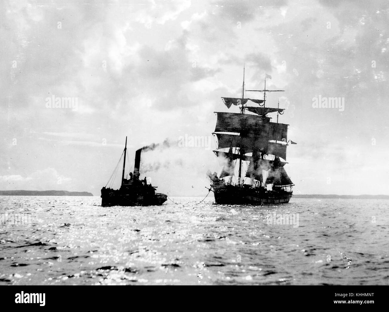 This image shows a ship crew member adjusting the slack in a towline ...