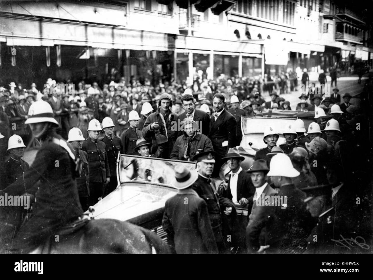 This photograph from 1928 shows people lined up along a Brisbane street ...