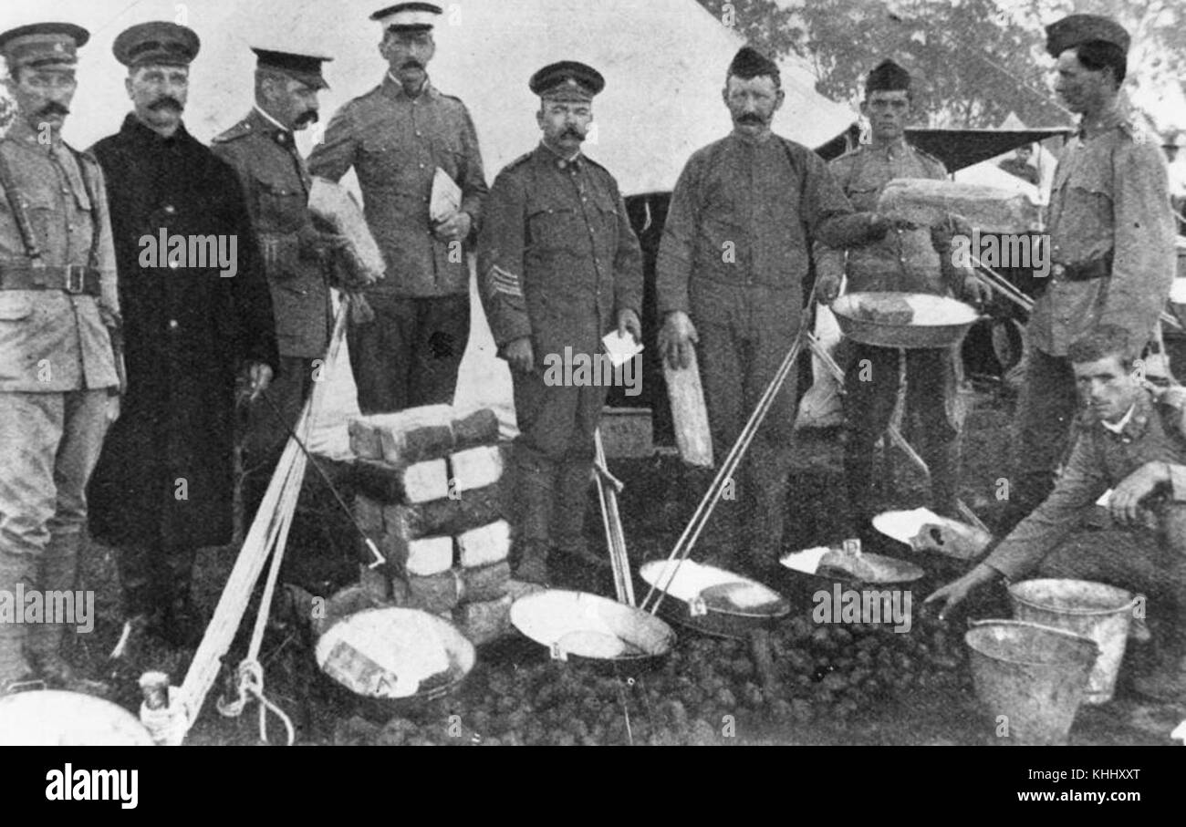 This historical photograph shows an inspection of rations in a camp at ...